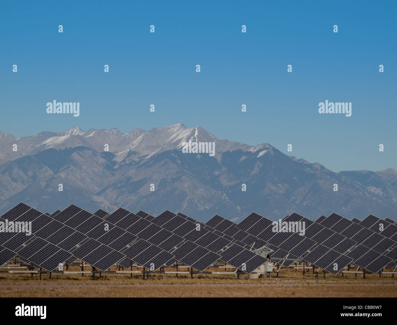 A series of large solar panels forms a symmetrical line at a power ...