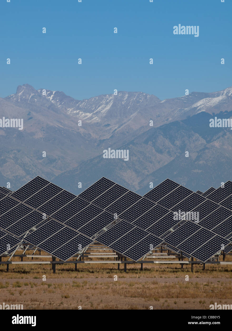 A series of large solar panels forms a symmetrical line at a power ...