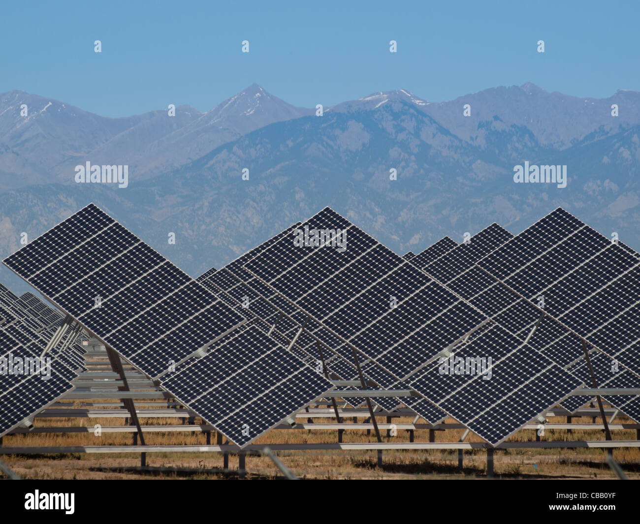 A series of large solar panels forms a symmetrical line at a power ...