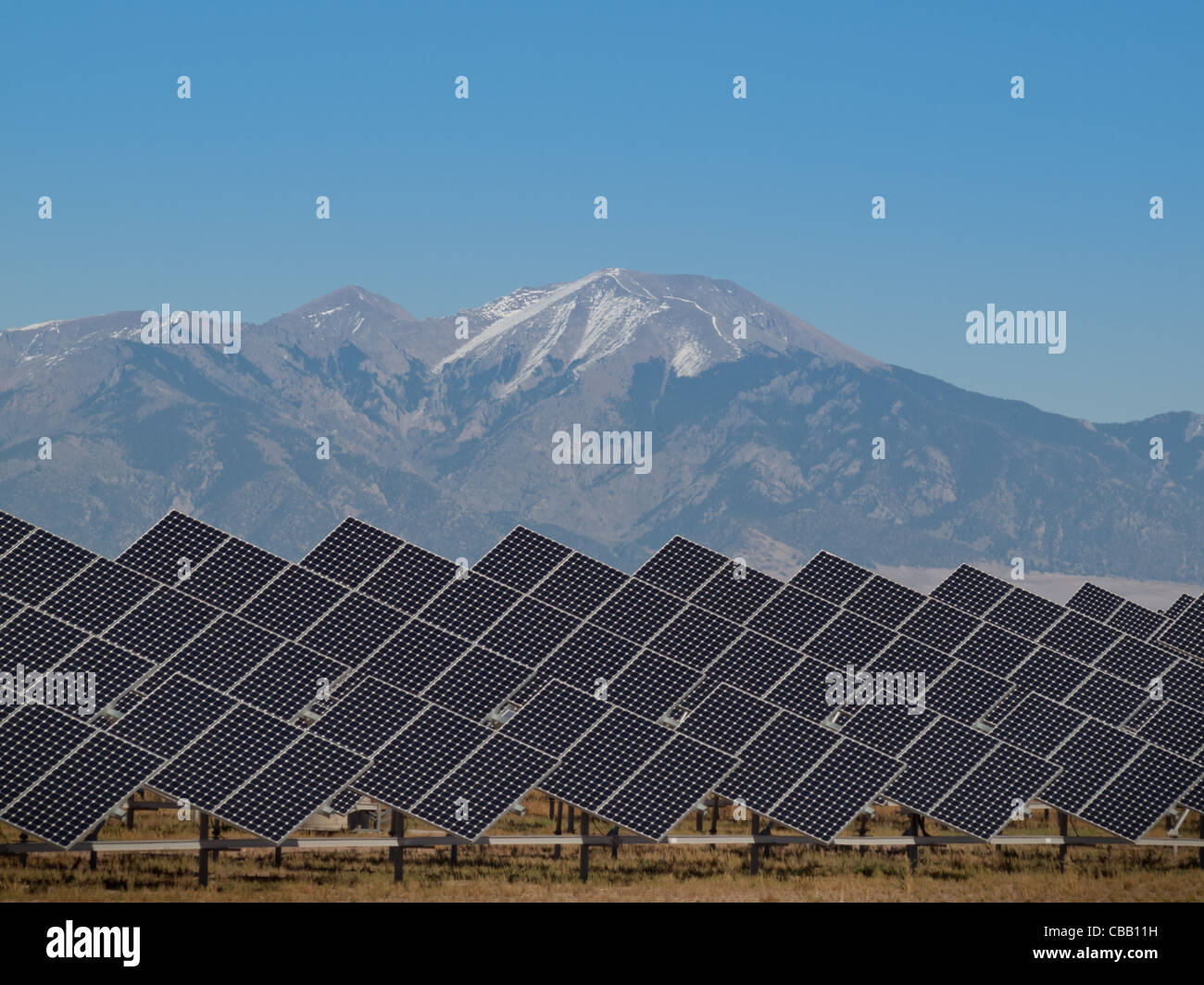 A series of large solar panels forms a symmetrical line at a power ...