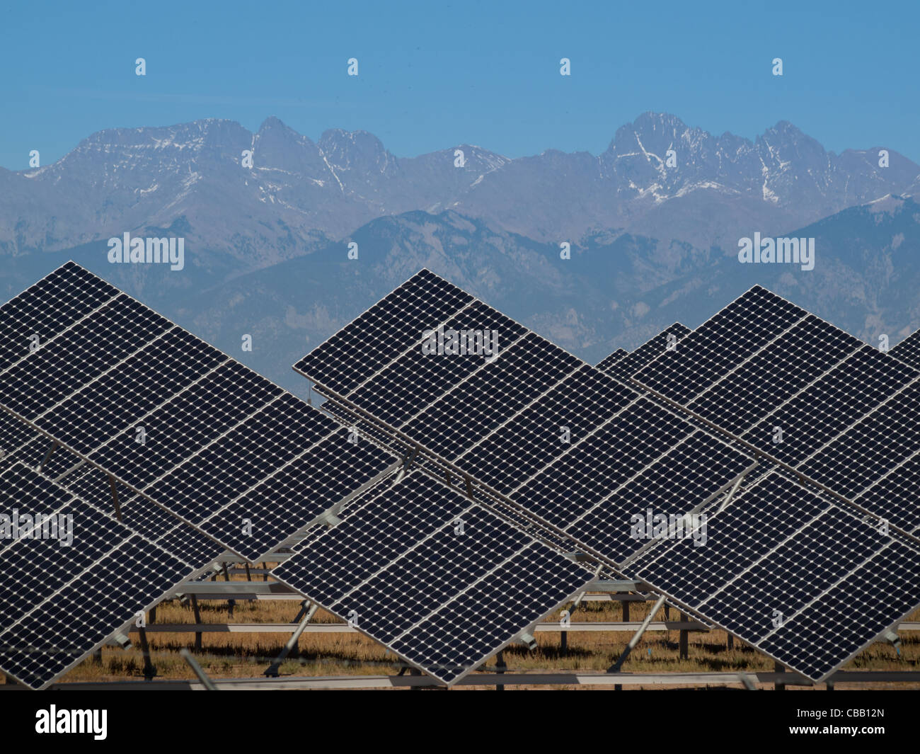 A series of large solar panels forms a symmetrical line at a power ...