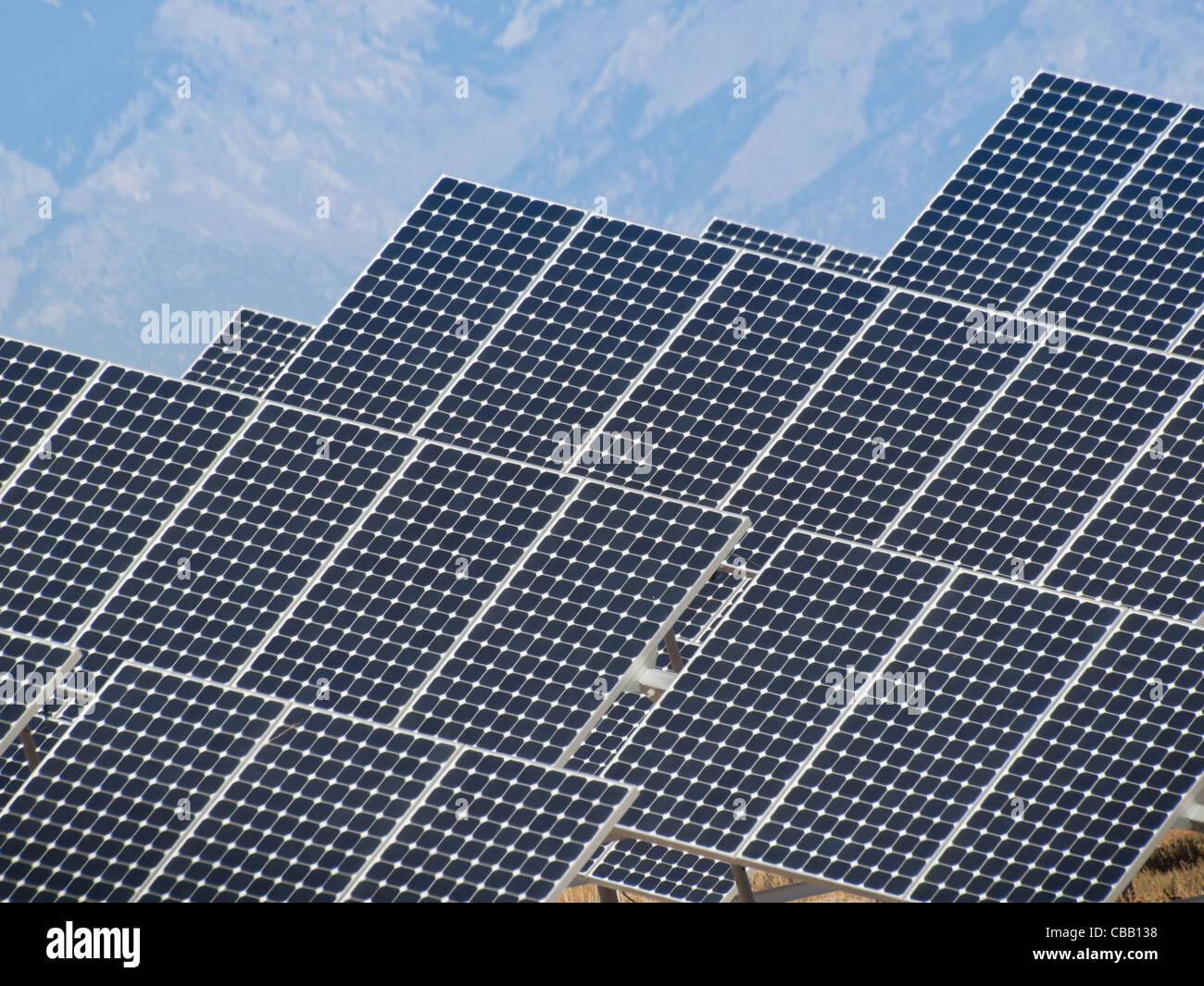 A series of large solar panels forms a symmetrical line at a power ...