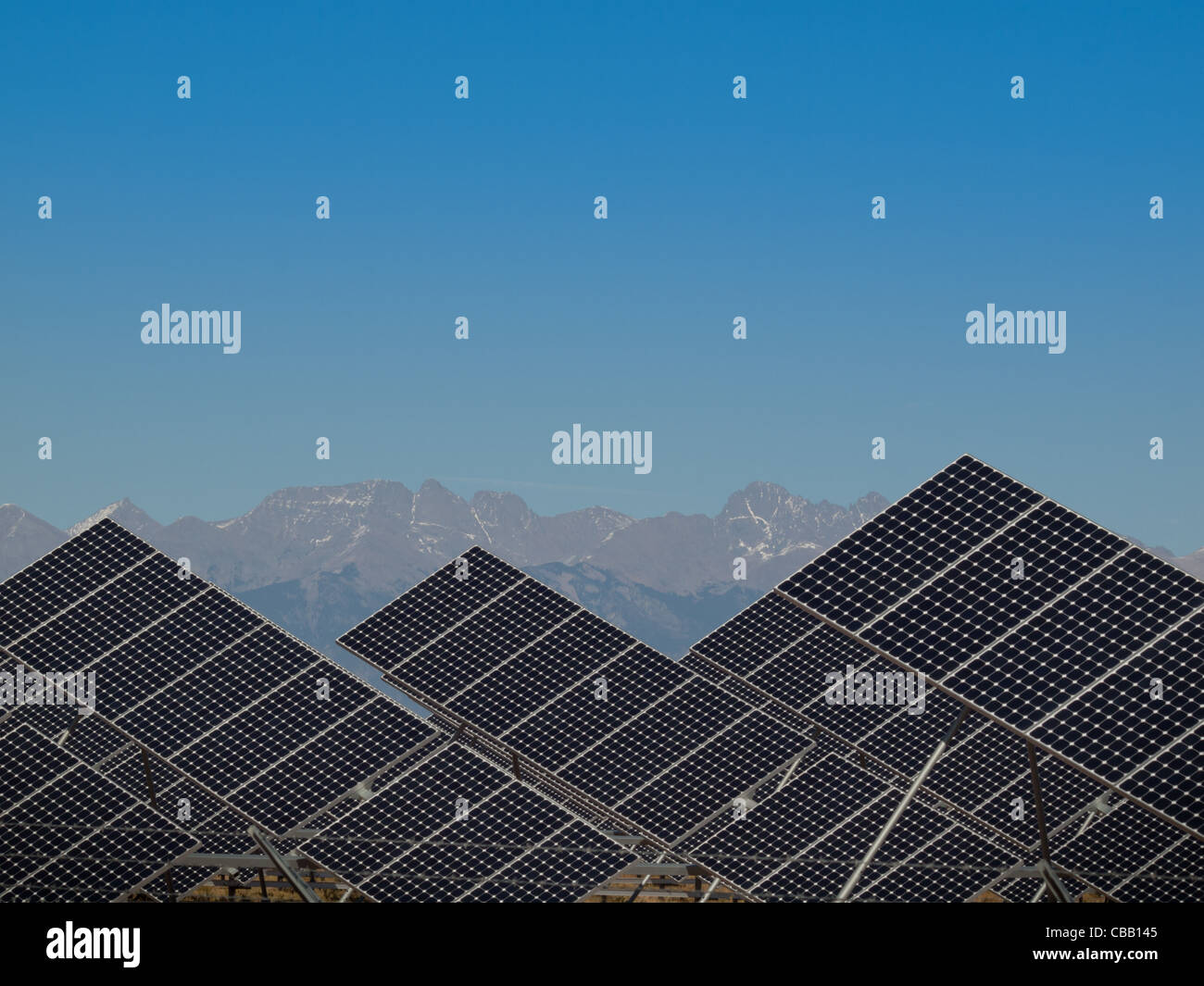 A series of large solar panels forms a symmetrical line at a power ...