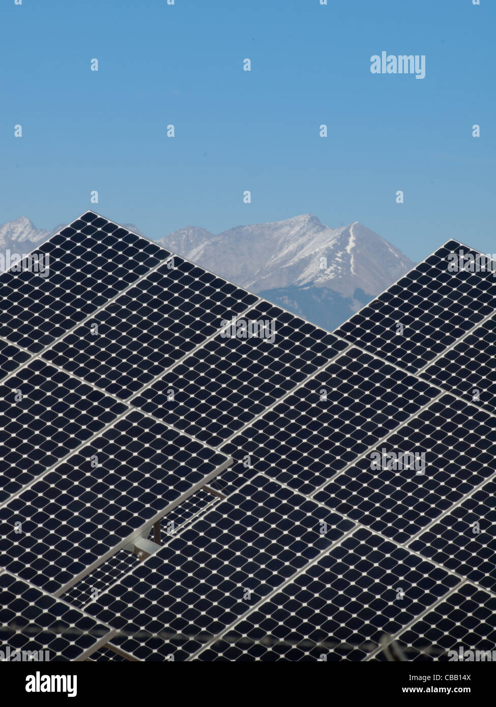 A series of large solar panels forms a symmetrical line at a power ...