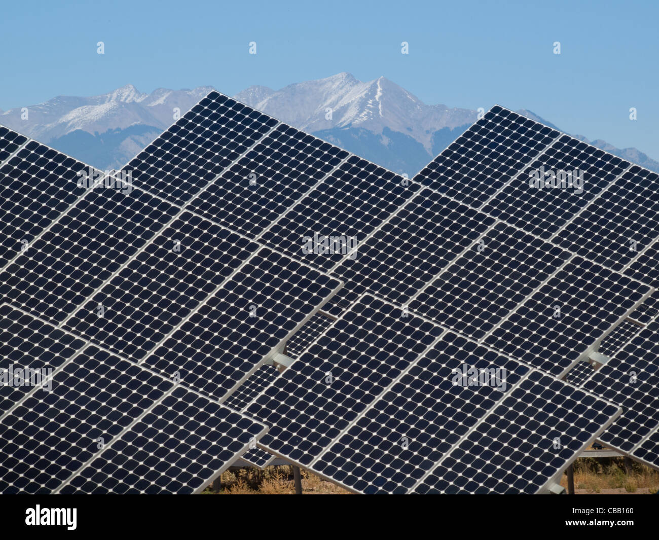 A series of large solar panels forms a symmetrical line at a power ...