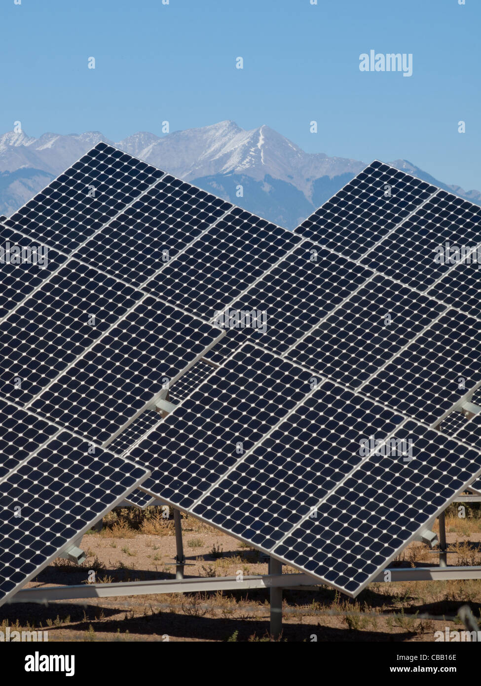 A series of large solar panels forms a symmetrical line at a power ...