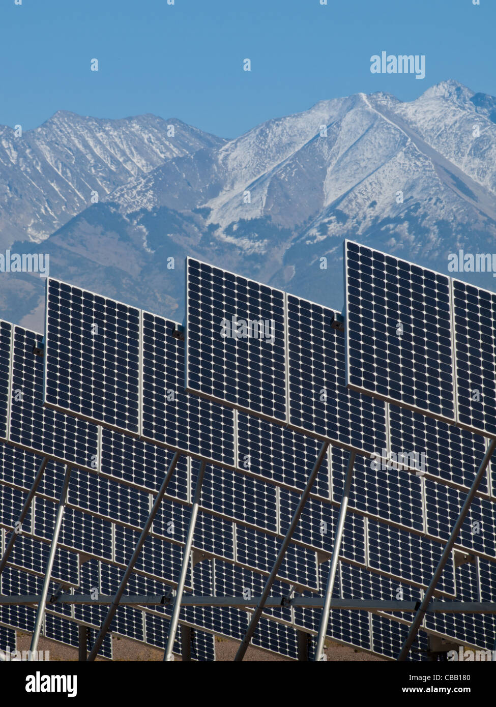 A series of large solar panels forms a symmetrical line at a power ...