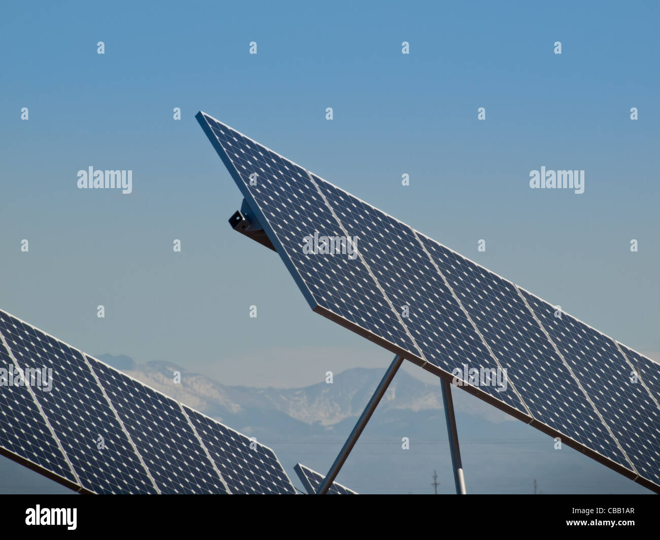 A series of large solar panels forms a symmetrical line at a power ...