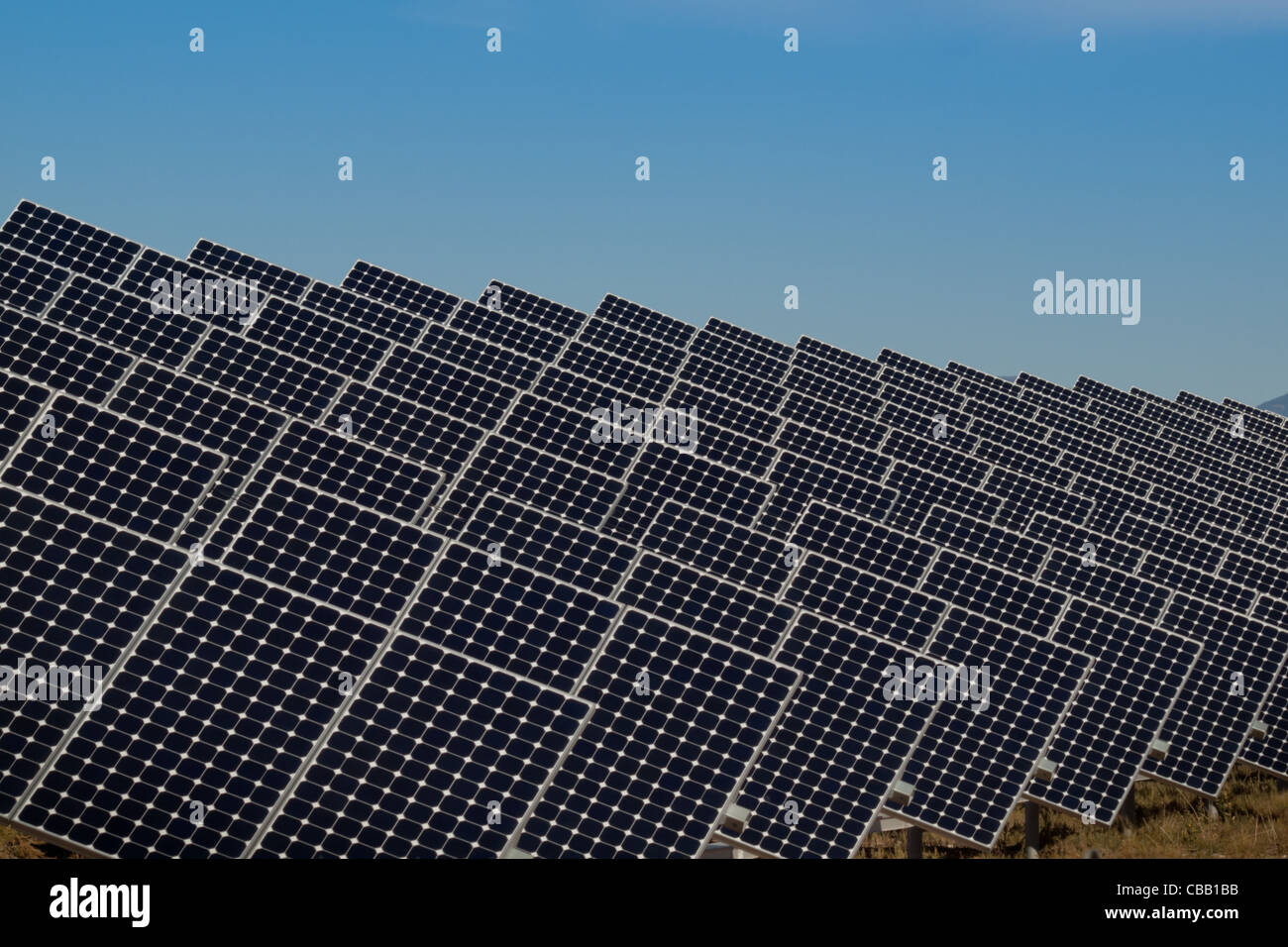 A series of large solar panels forms a symmetrical line at a power ...