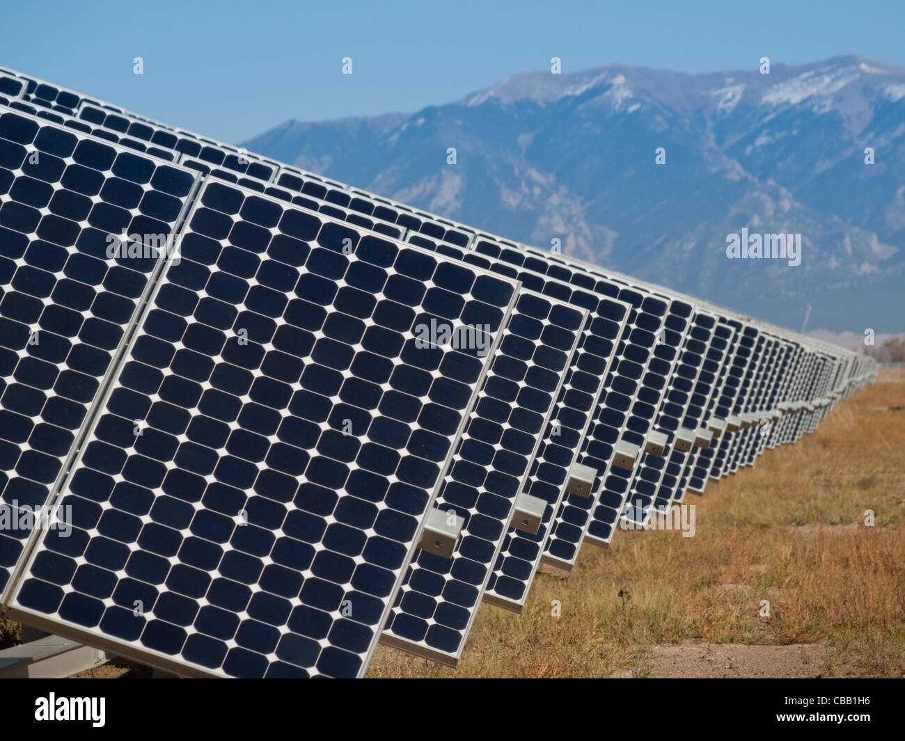 A series of large solar panels forms a symmetrical line at a power ...
