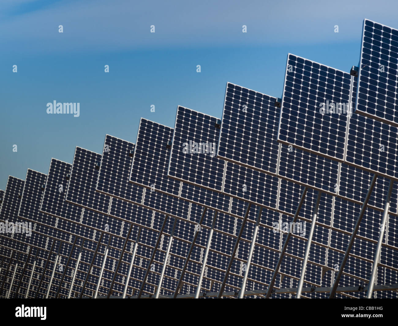 A series of large solar panels forms a symmetrical line at a power ...