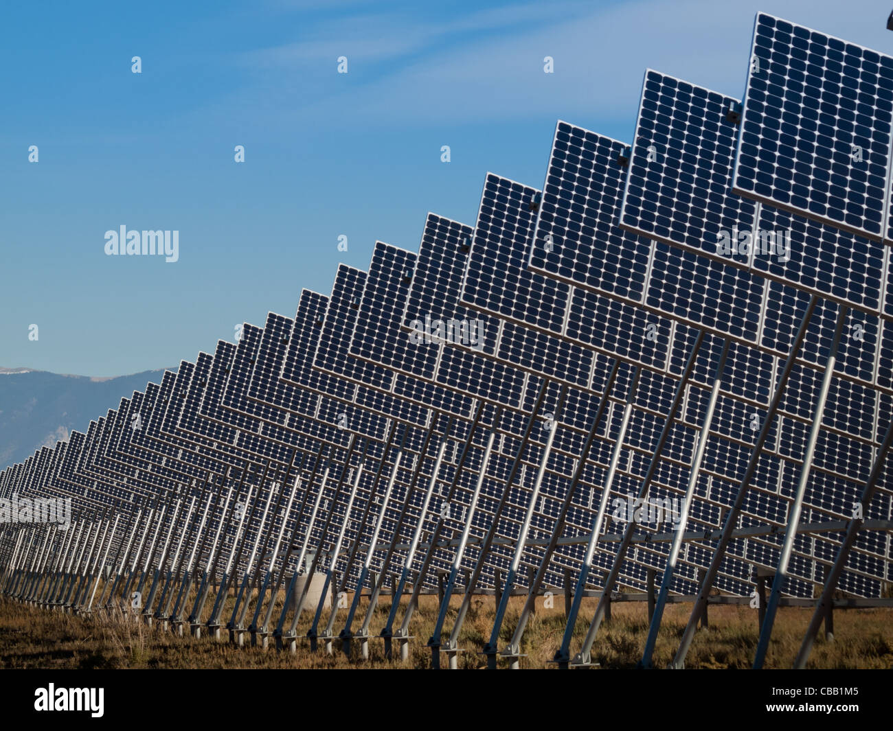 A series of large solar panels forms a symmetrical line at a power ...