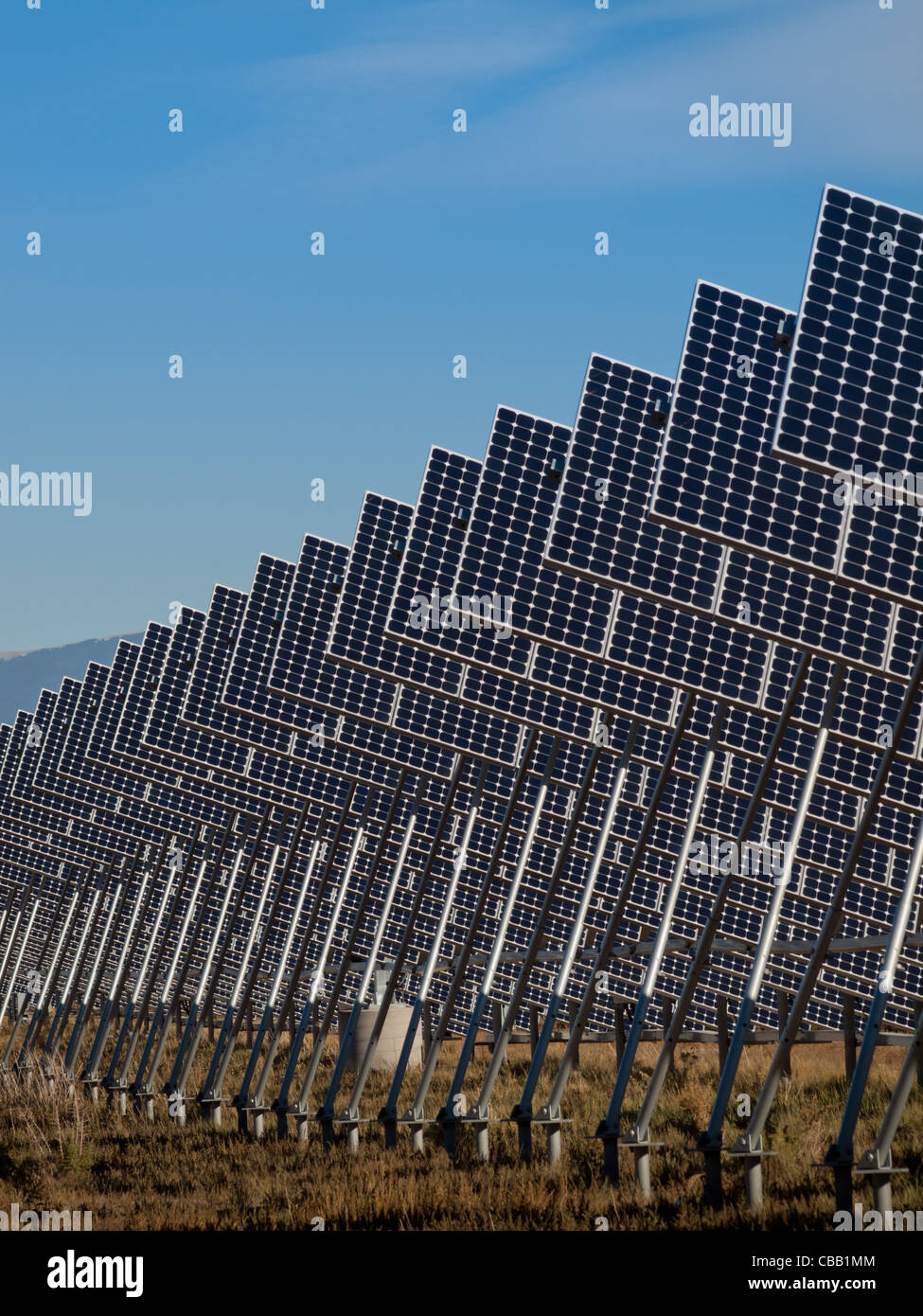 A series of large solar panels forms a symmetrical line at a power ...