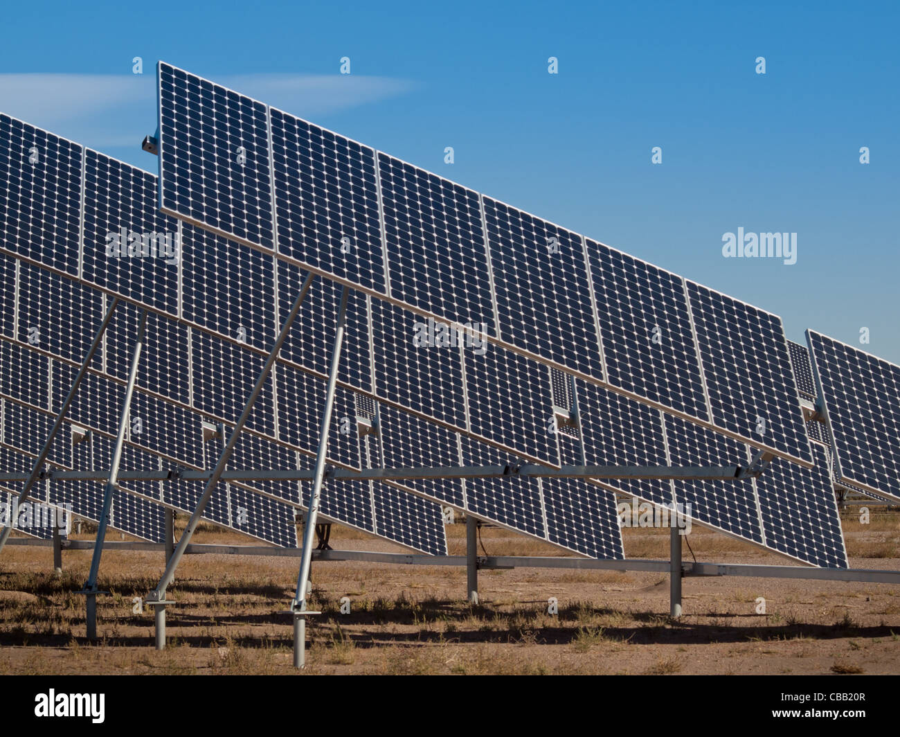 A series of large solar panels forms a symmetrical line at a power ...