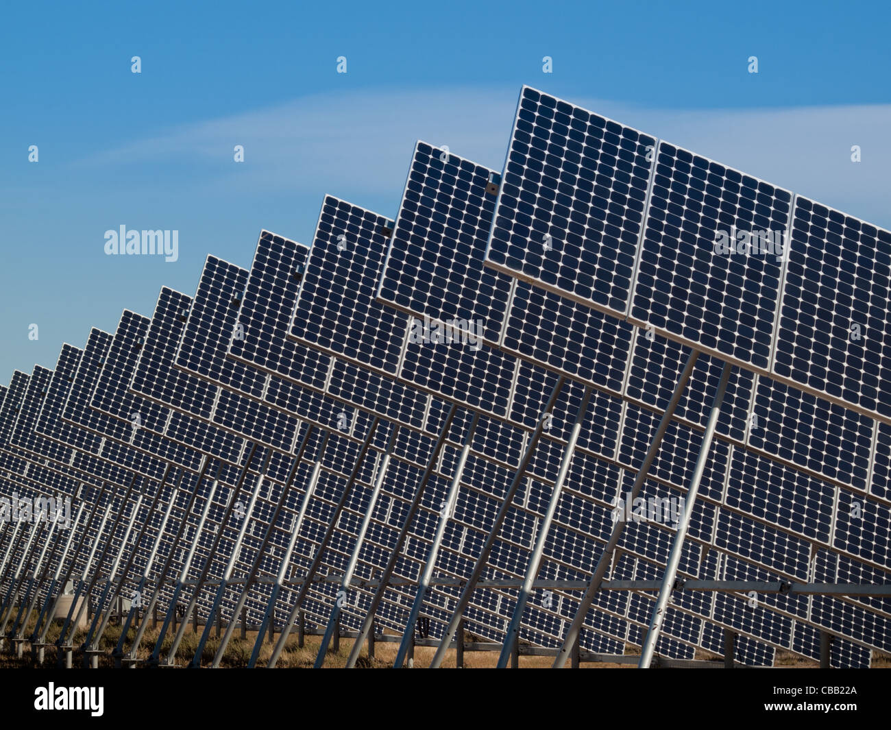 A series of large solar panels forms a symmetrical line at a power ...