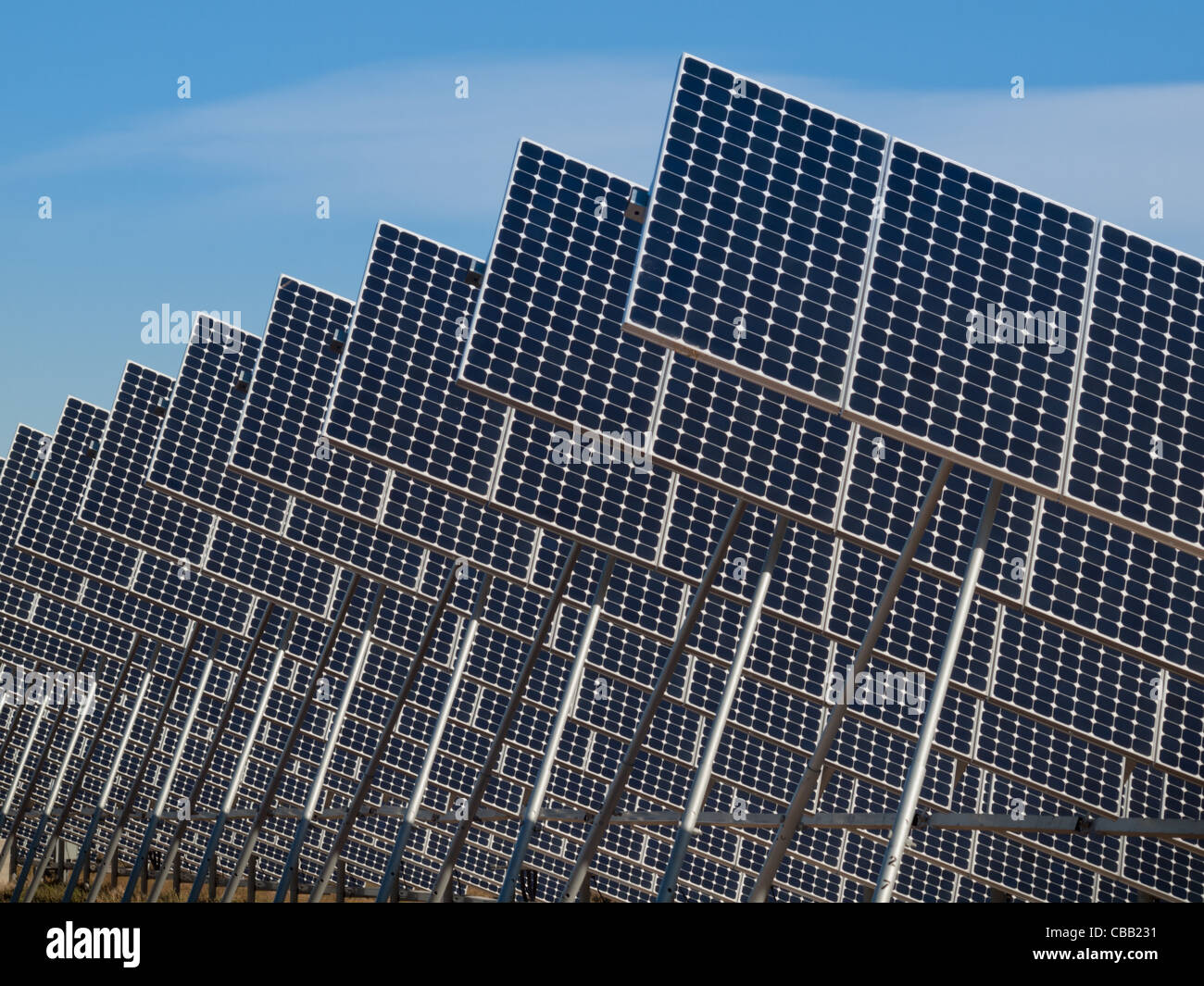 A series of large solar panels forms a symmetrical line at a power ...