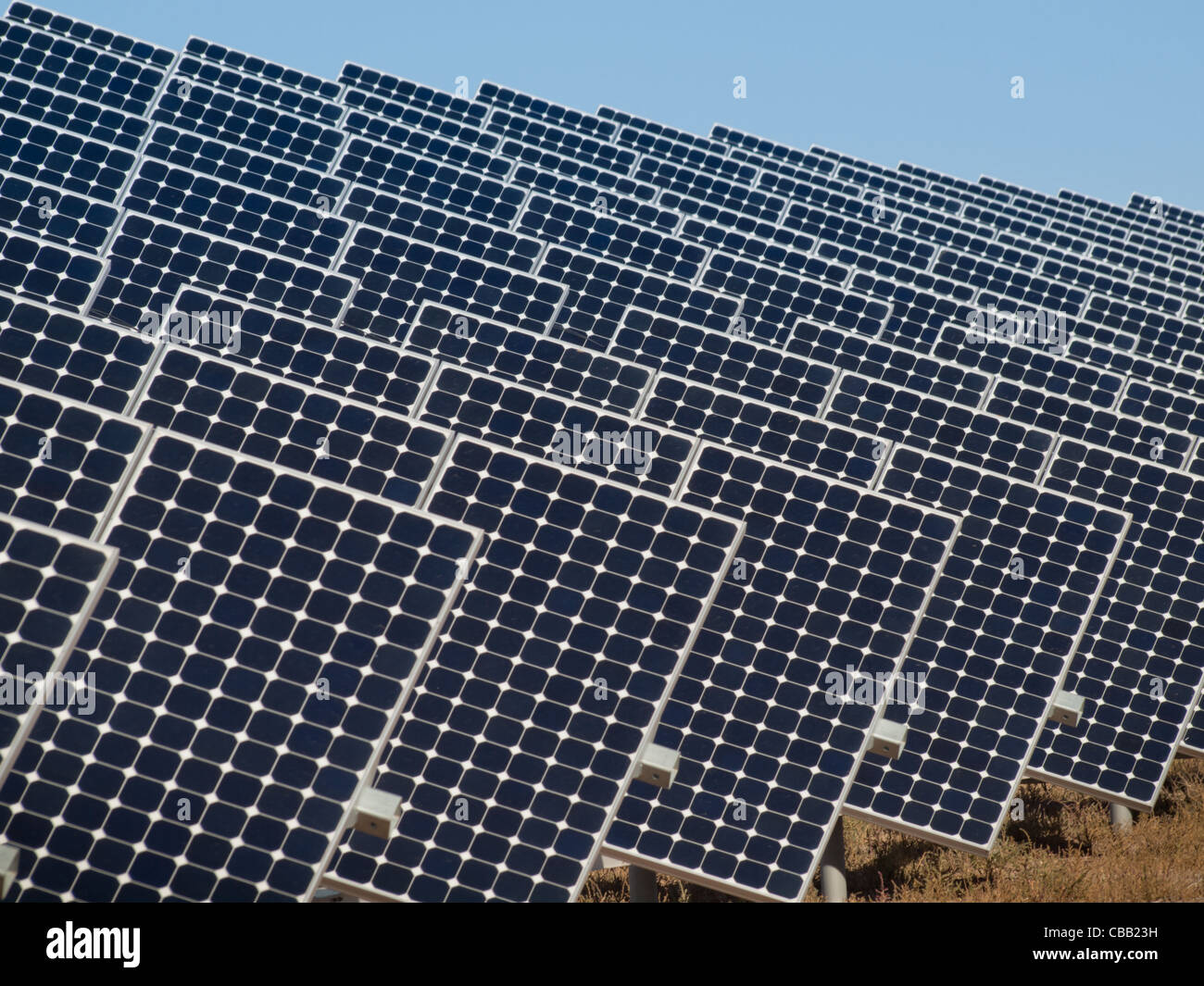 A series of large solar panels forms a symmetrical line at a power ...