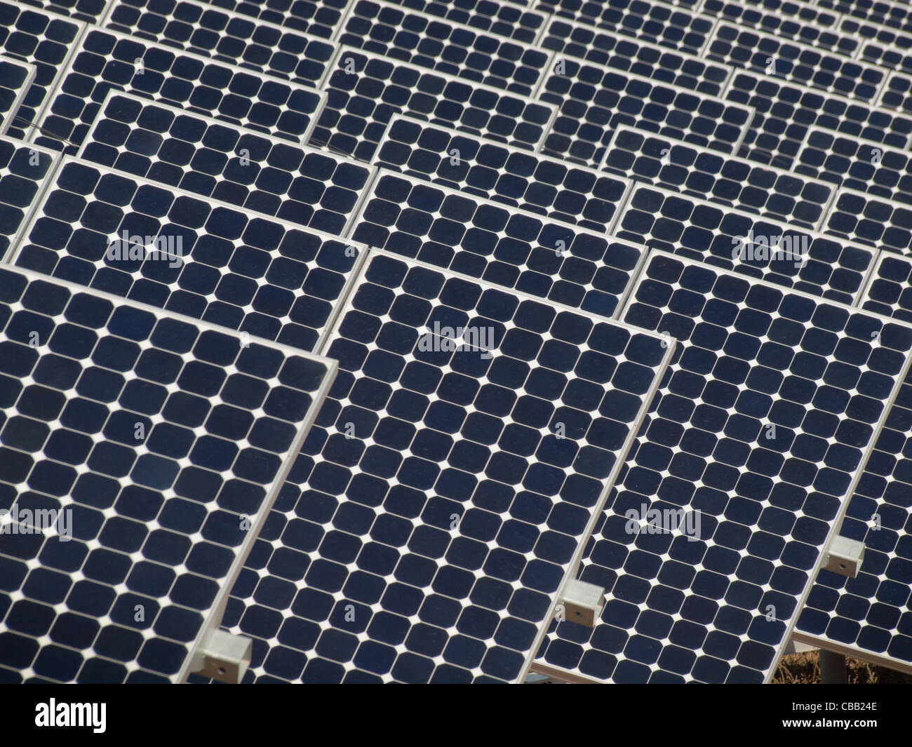 A series of large solar panels forms a symmetrical line at a power ...