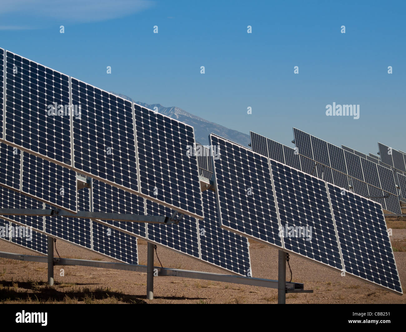 A series of large solar panels forms a symmetrical line at a power ...