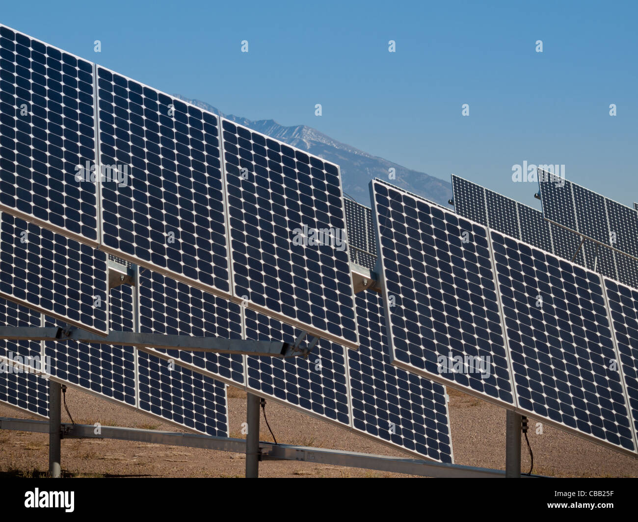 A series of large solar panels forms a symmetrical line at a power ...