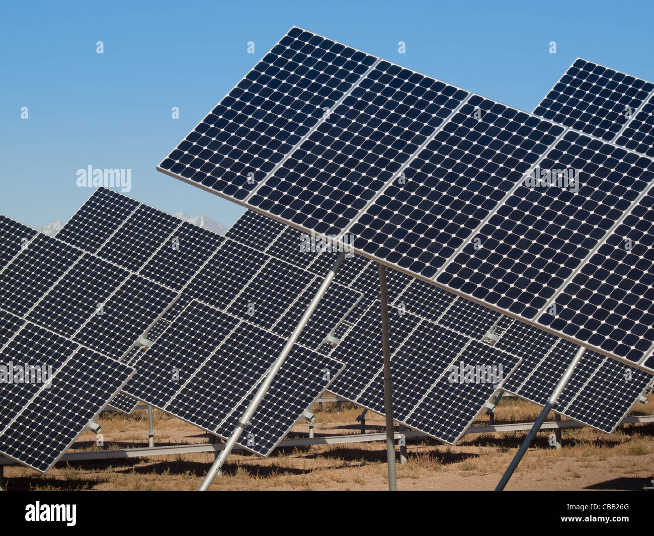 A series of large solar panels forms a symmetrical line at a power ...