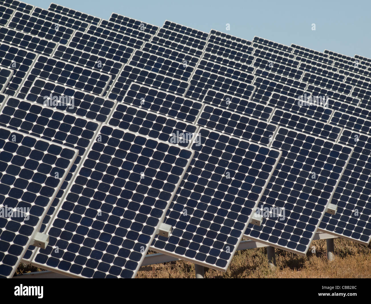 A series of large solar panels forms a symmetrical line at a power ...