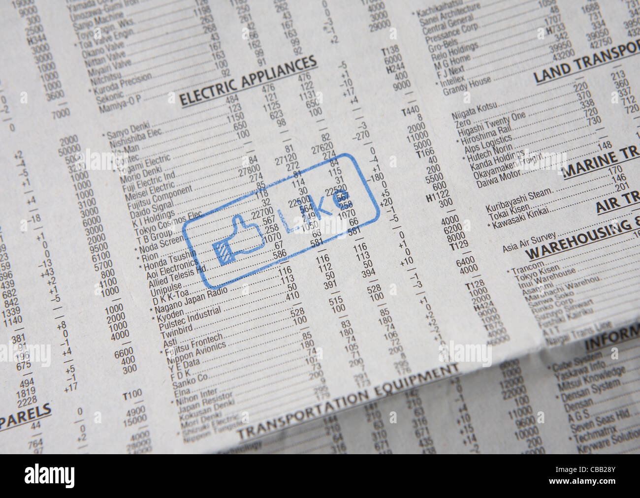 Newspaper section of the stock market with "like" stamp Stock Photo - Alamy
