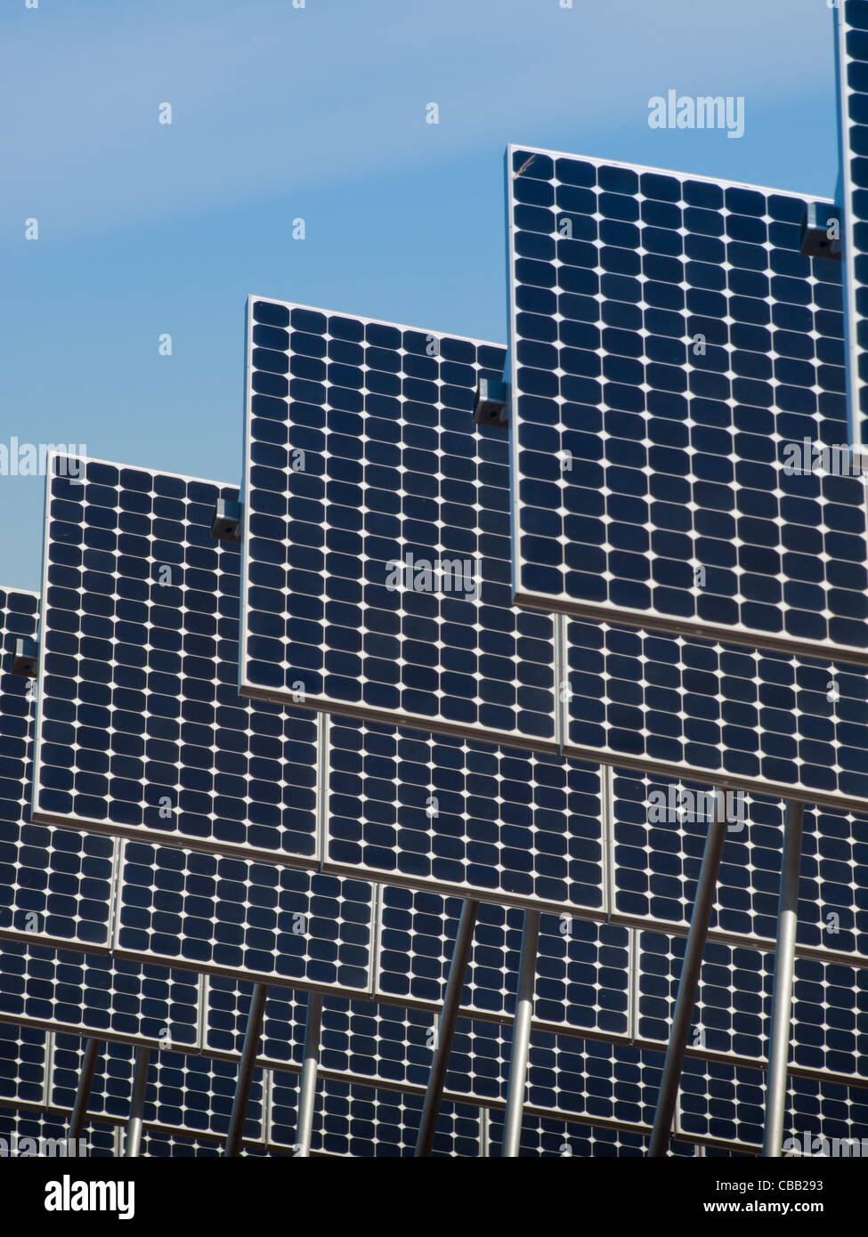 A series of large solar panels forms a symmetrical line at a power ...