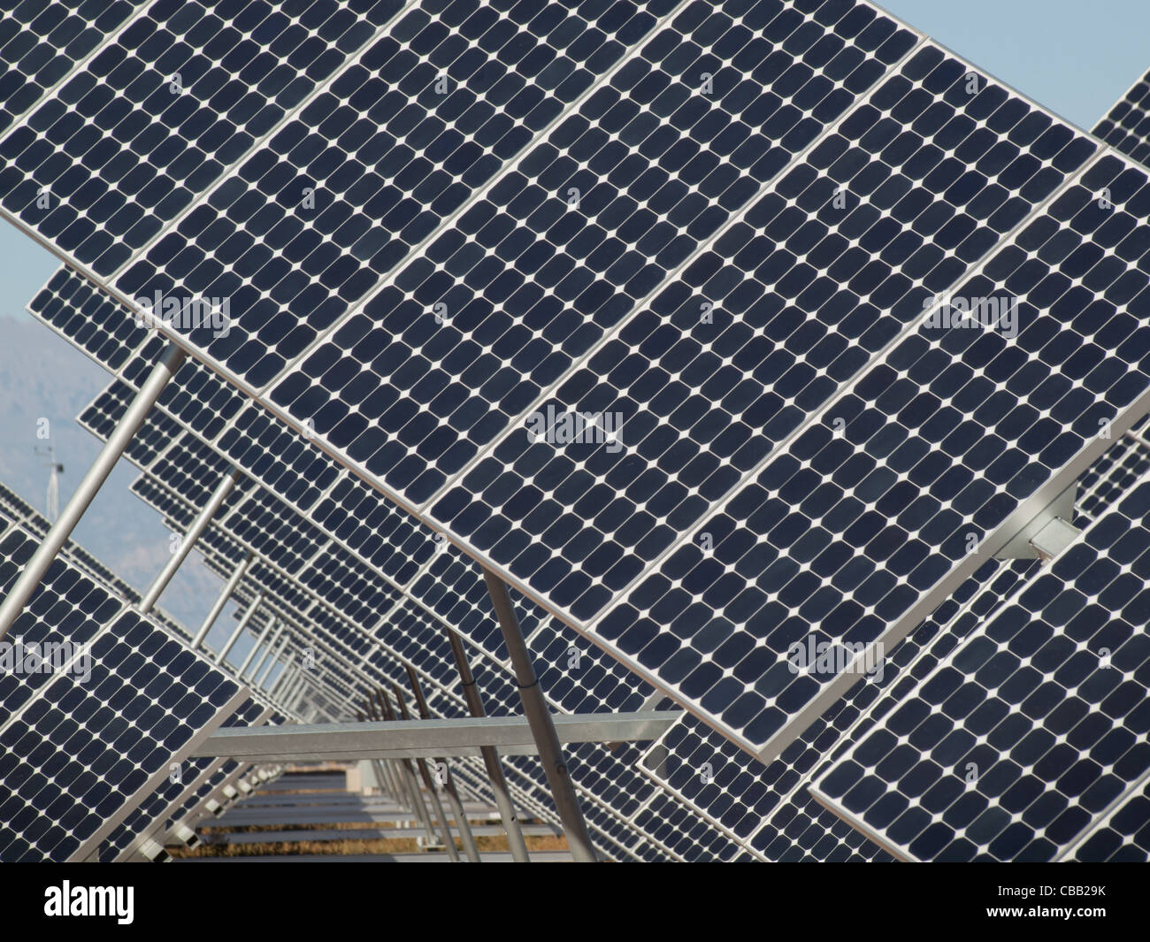 A series of large solar panels forms a symmetrical line at a power ...