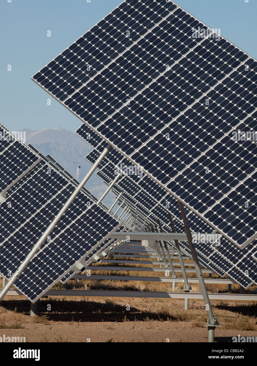 A series of large solar panels forms a symmetrical line at a power ...