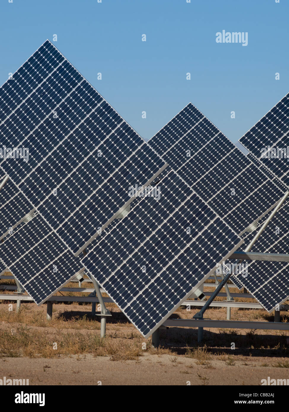 A series of large solar panels forms a symmetrical line at a power ...