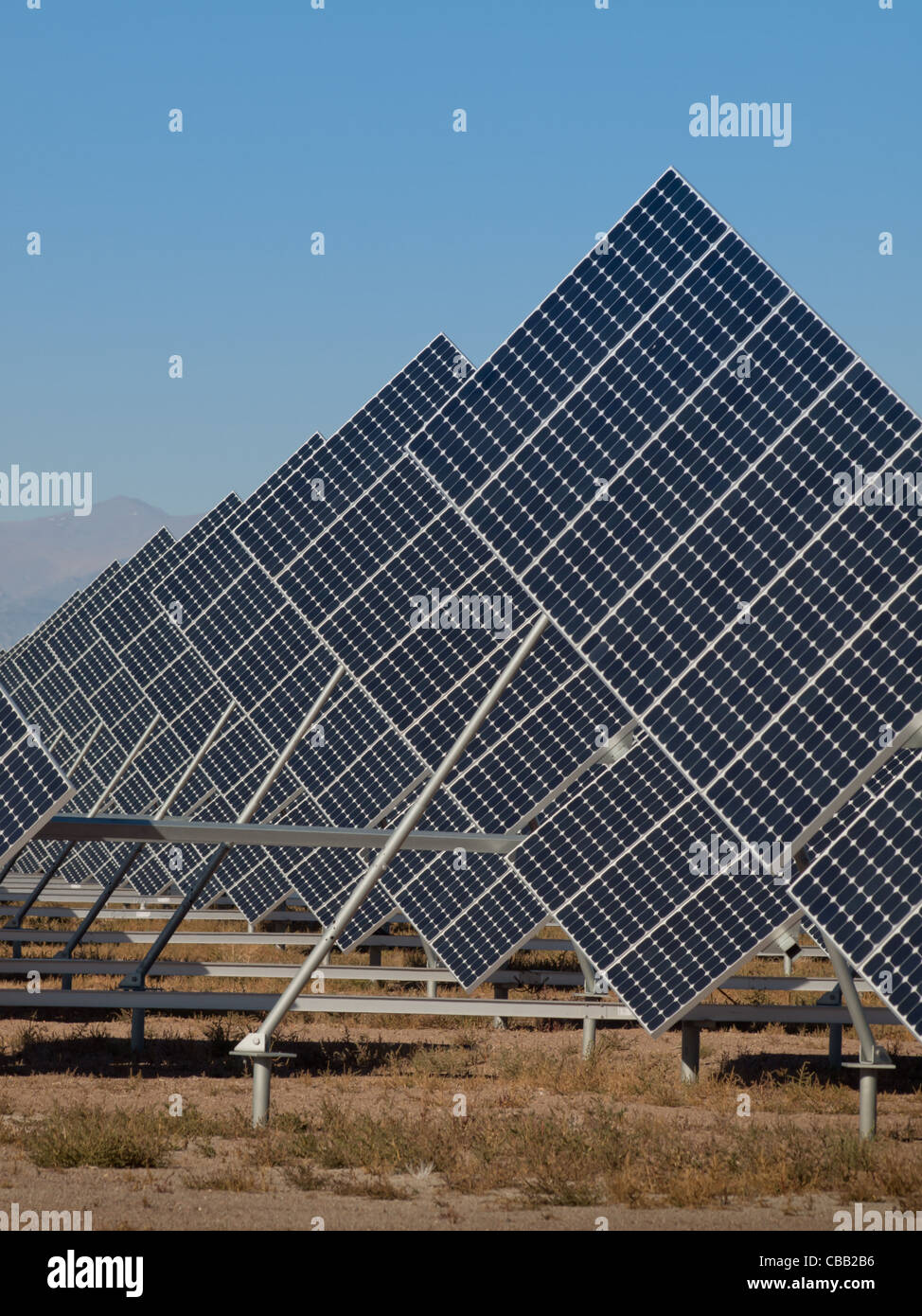 A series of large solar panels forms a symmetrical line at a power ...