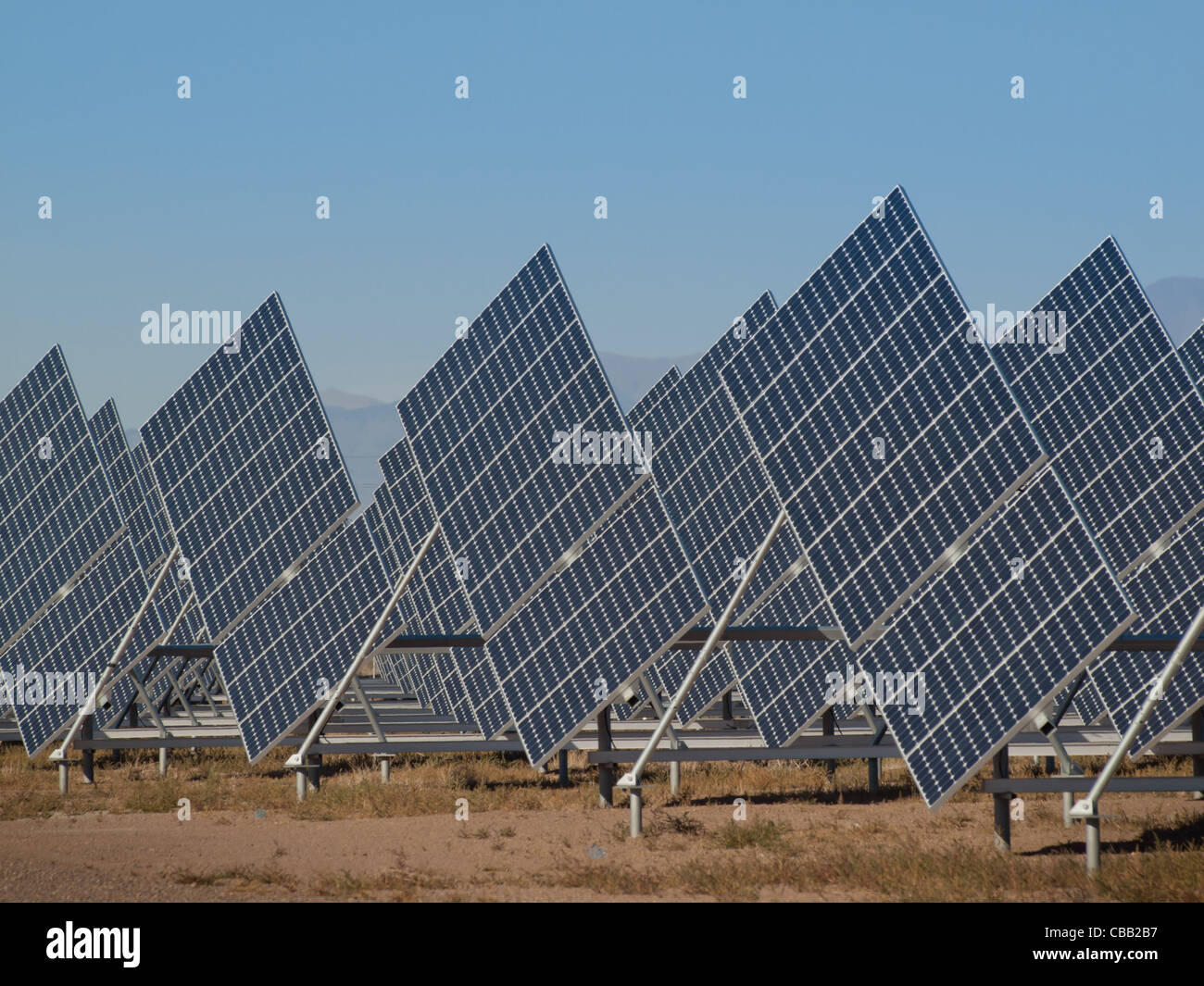 A series of large solar panels forms a symmetrical line at a power ...