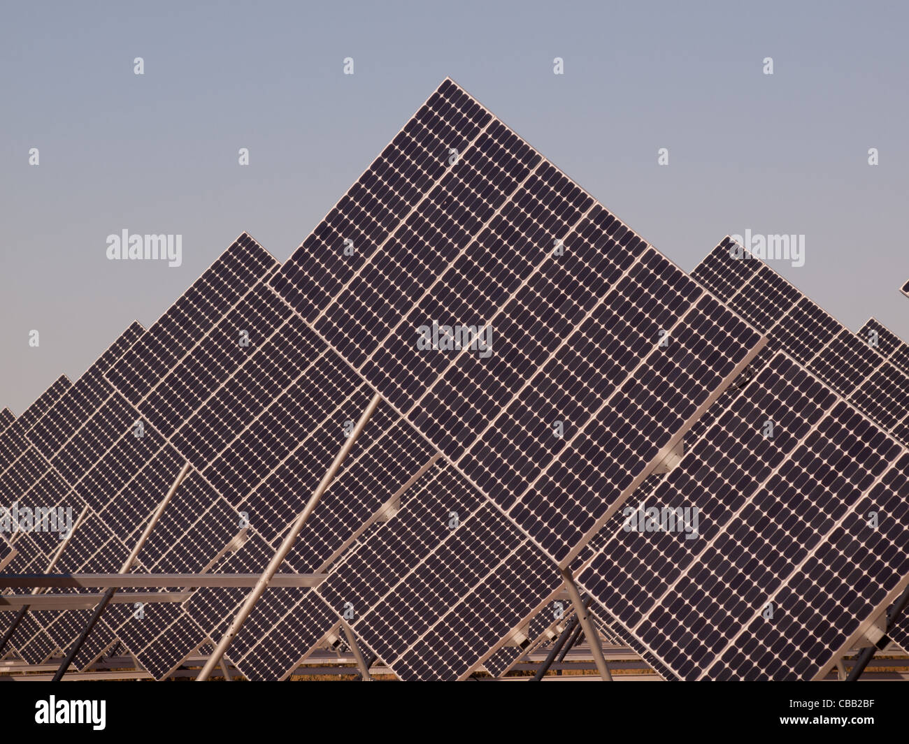 A series of large solar panels forms a symmetrical line at a power ...