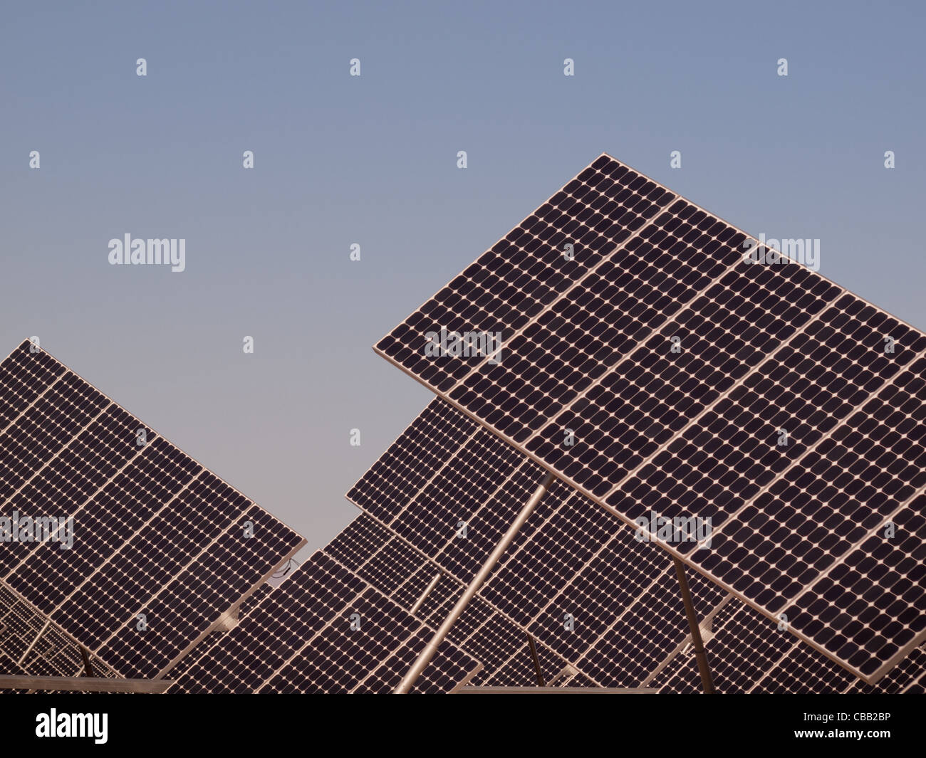A series of large solar panels forms a symmetrical line at a power ...