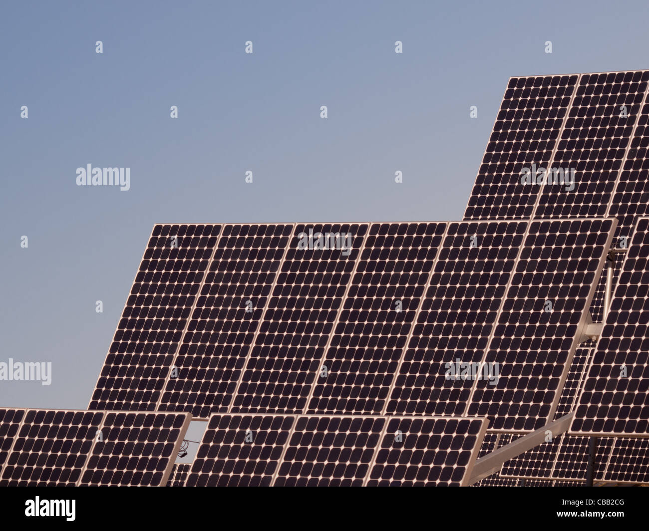 A series of large solar panels forms a symmetrical line at a power ...