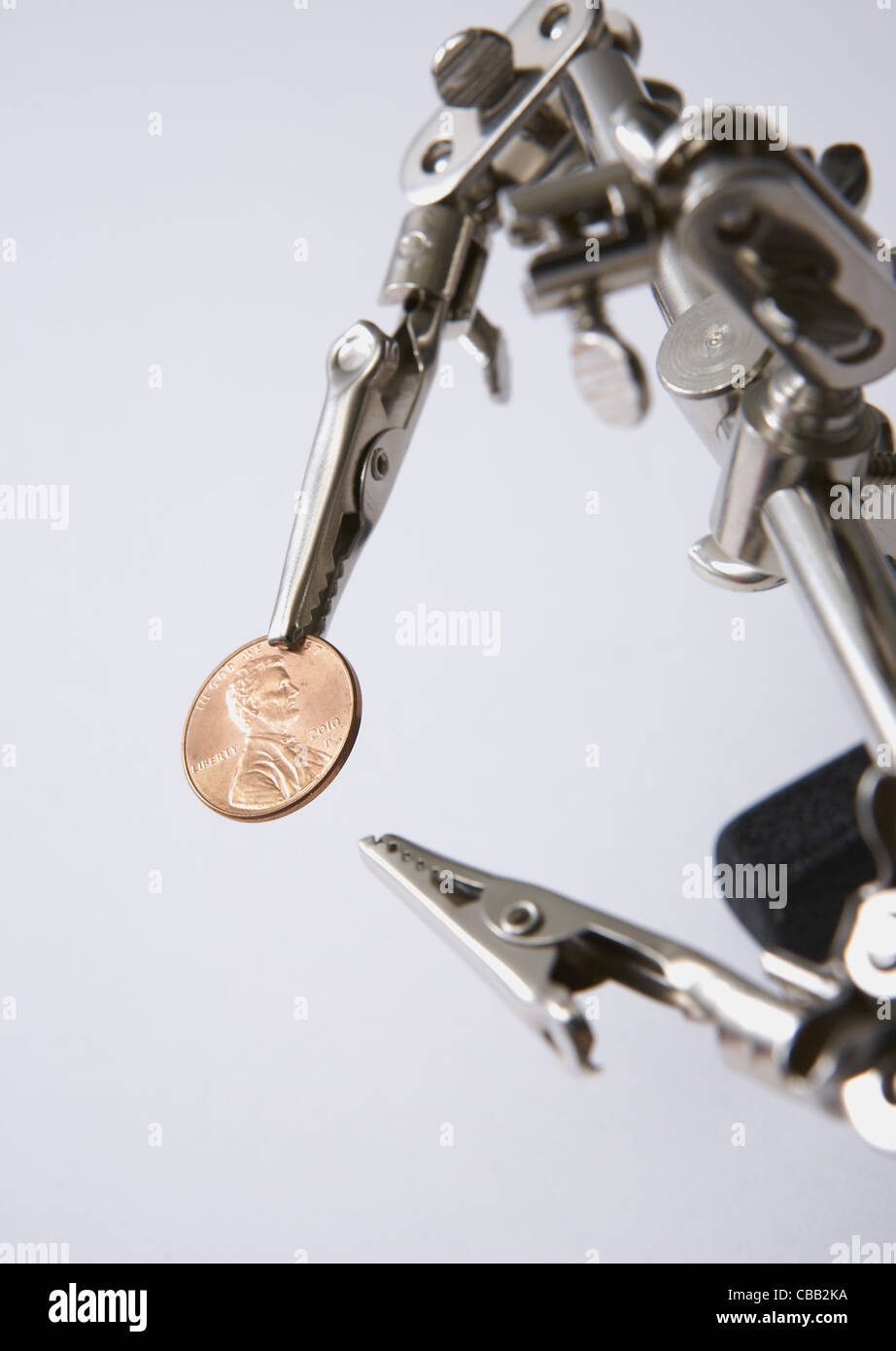 Helping hand holding coin Stock Photo - Alamy