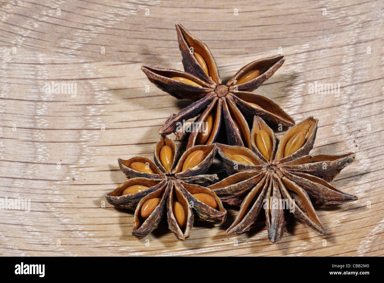 Close up of three star anise fruits in a wooden bowl Stock Photo - Alamy