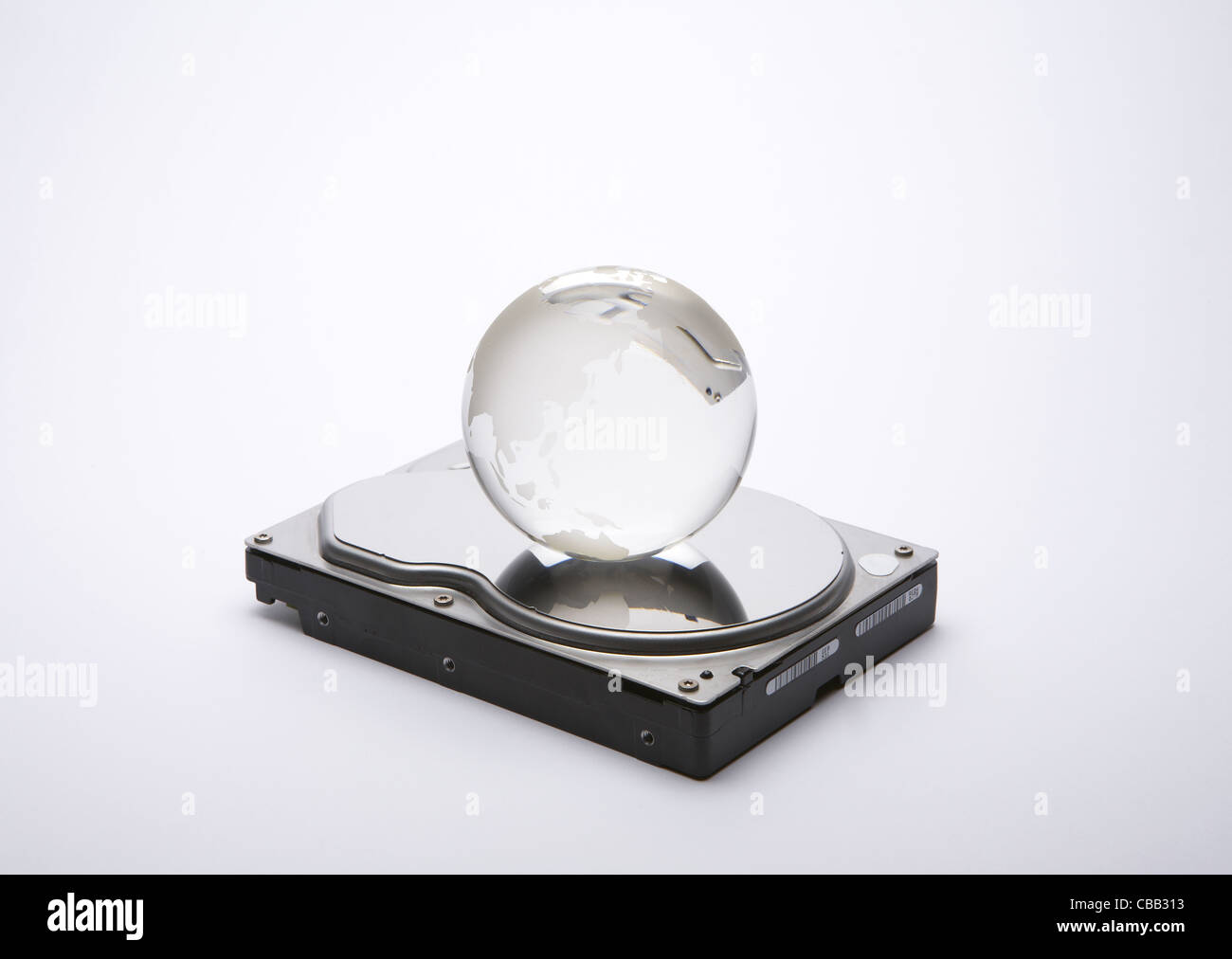 Glass globe on hard disk Stock Photo - Alamy