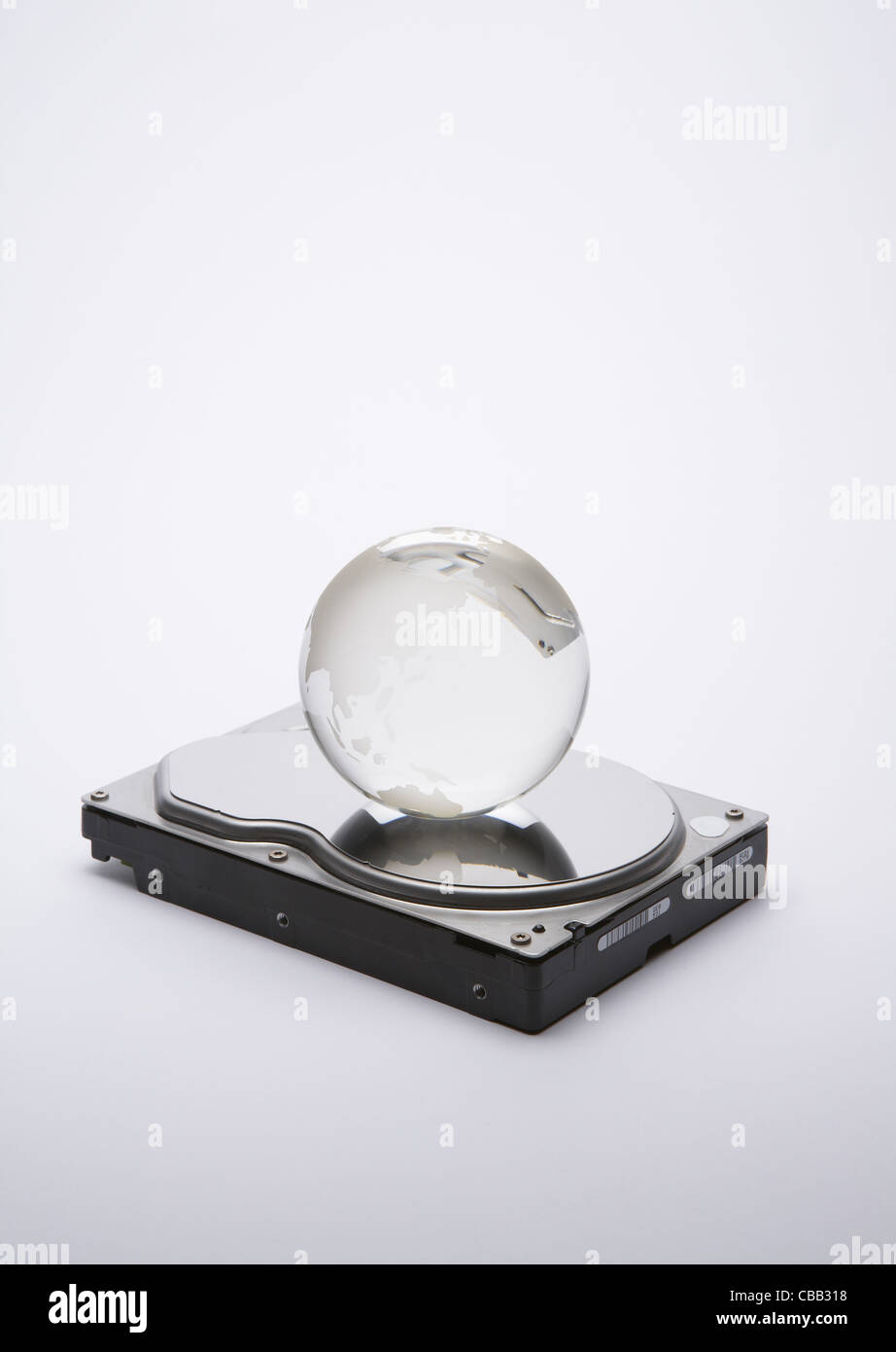 Glass globe on hard disk Stock Photo - Alamy