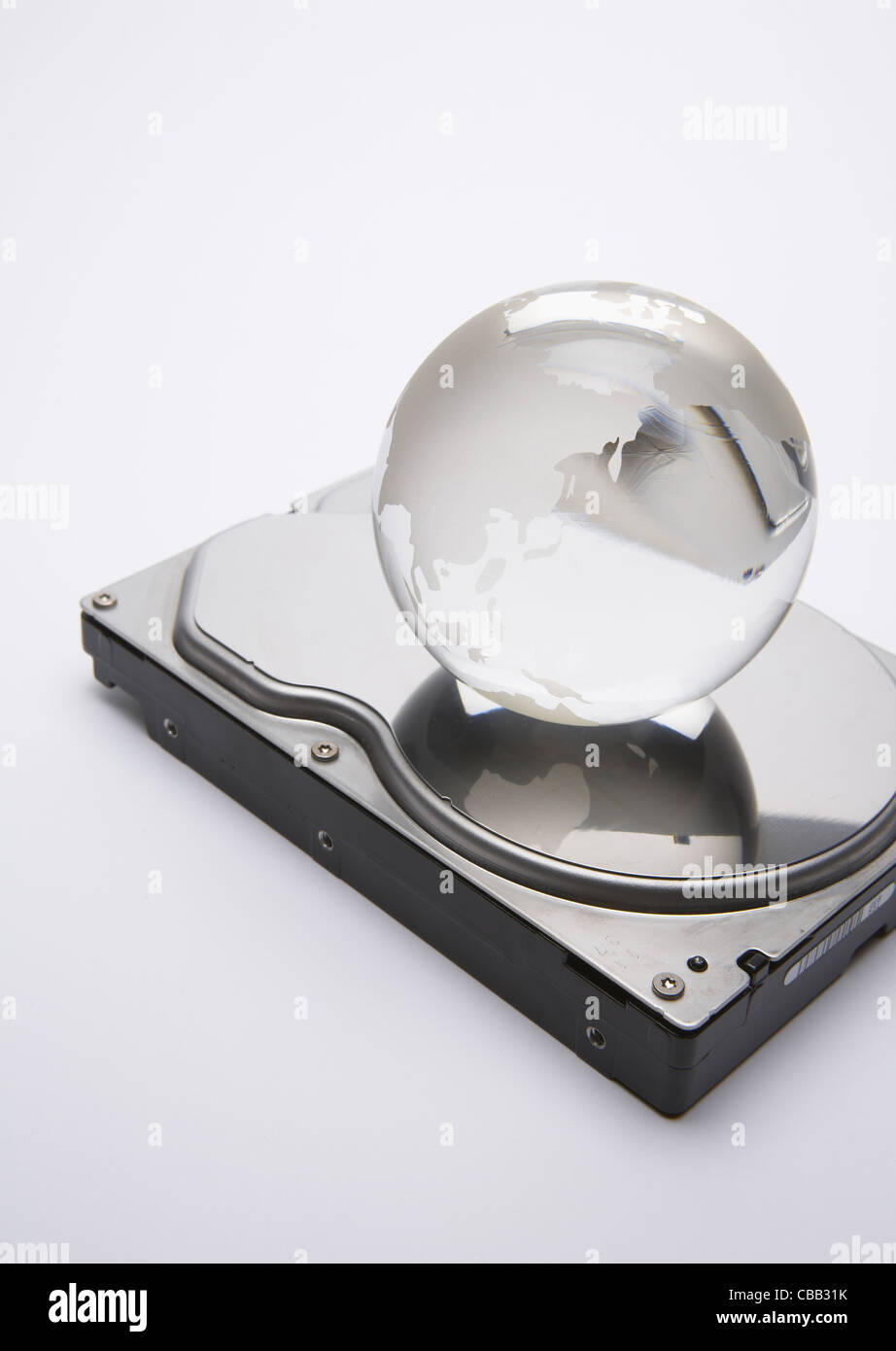 Glass globe on hard disk Stock Photo - Alamy