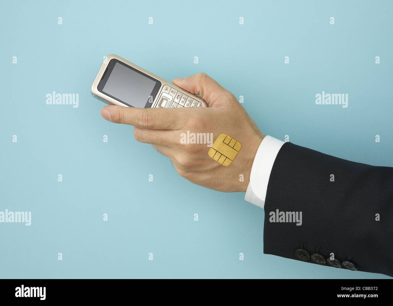 Businessman's hand with IC chip holding mobile phone Stock Photo - Alamy