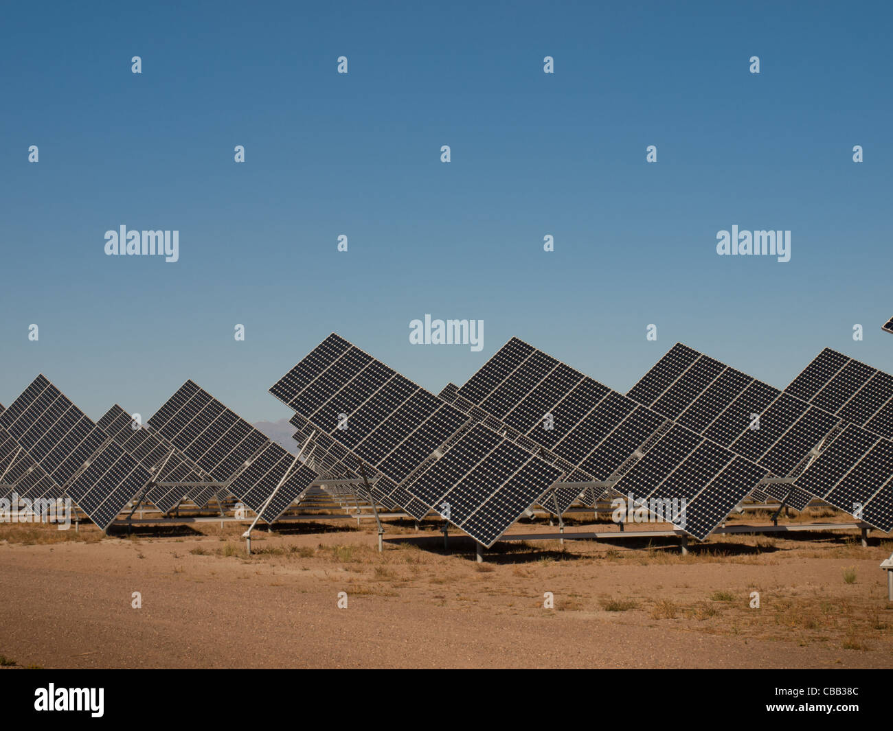 A series of large solar panels forms a symmetrical line at a power ...