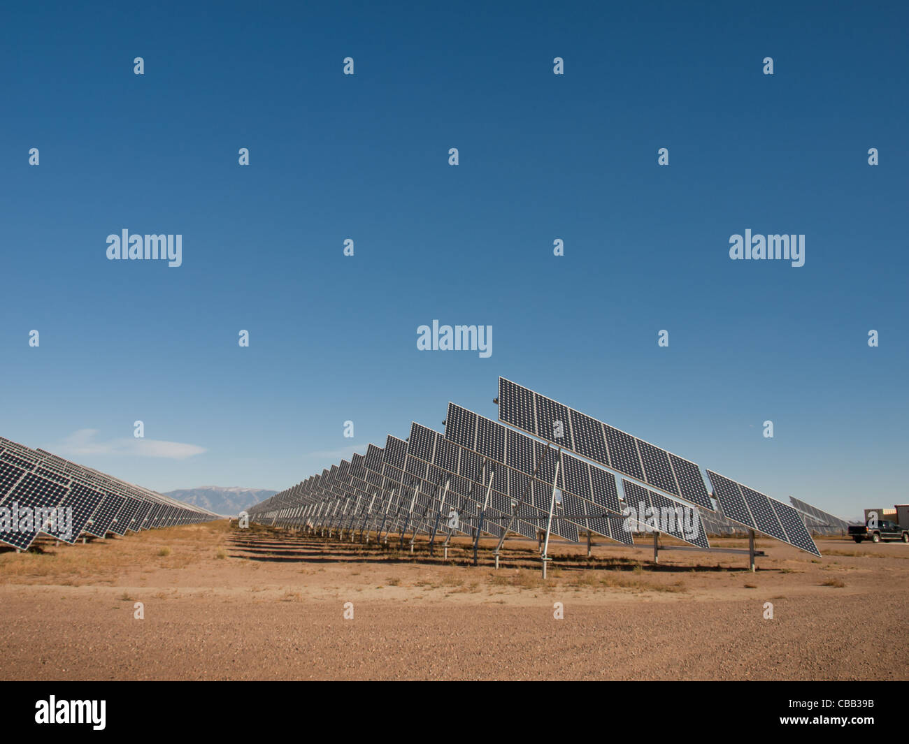 A series of large solar panels forms a symmetrical line at a power ...