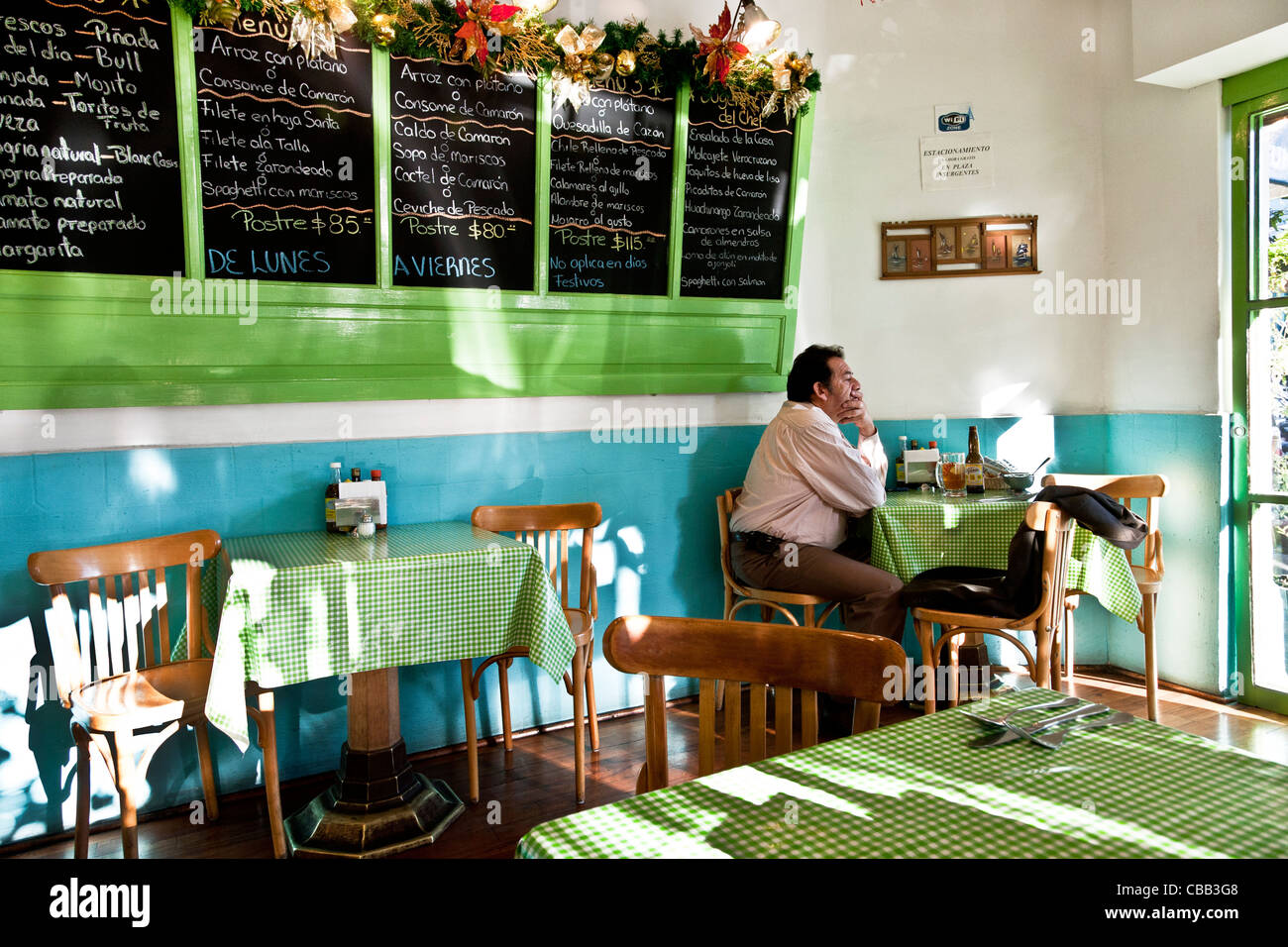 seated middle class Mexican man awaiting lunch in clean simple sunny ...