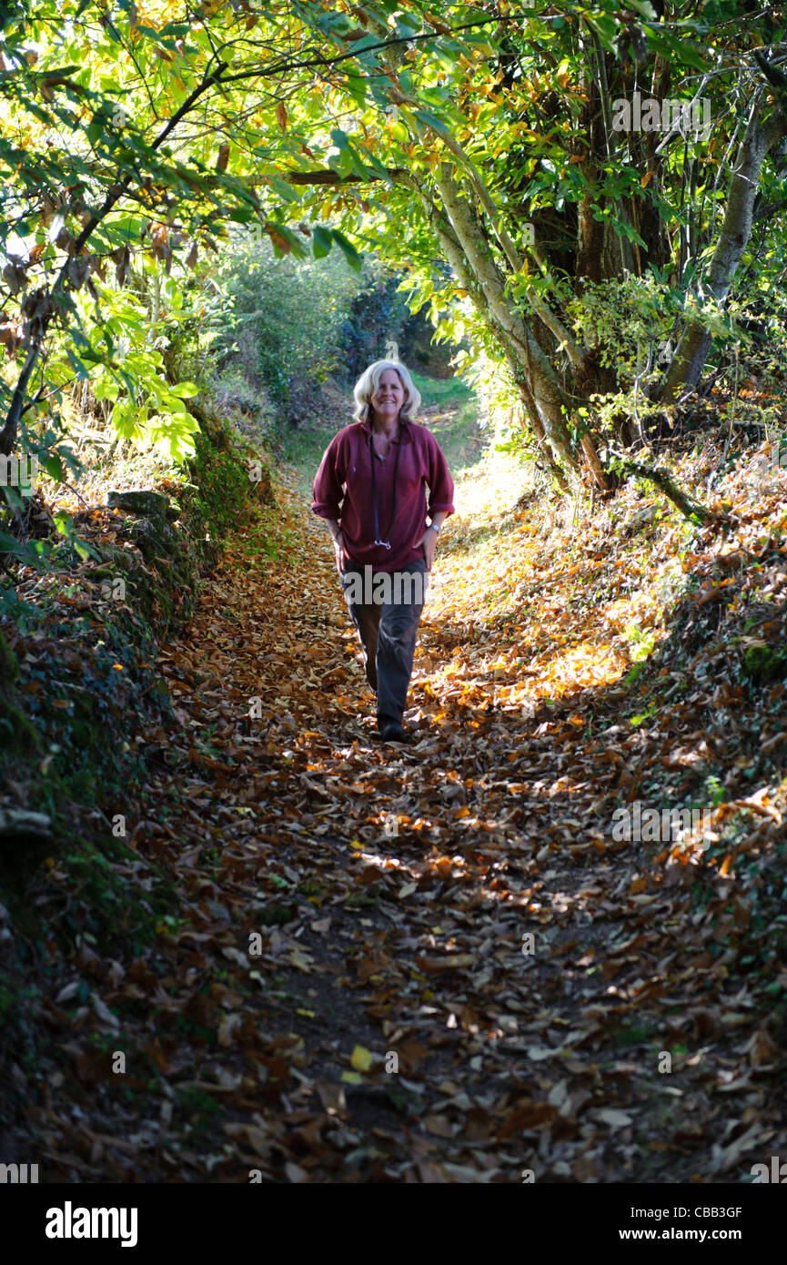Woman walking down country lane hi-res stock photography and images - Alamy