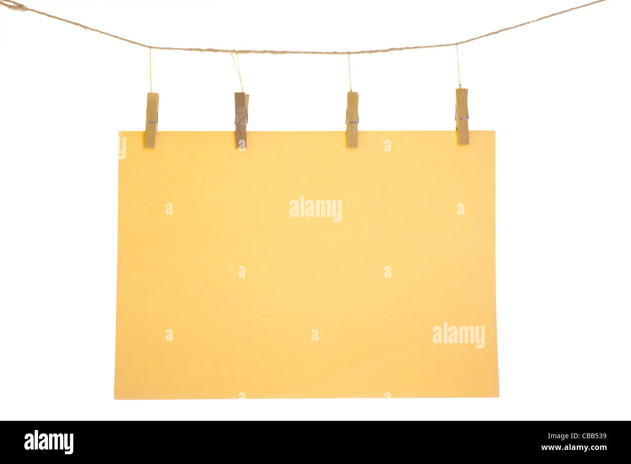 Orange blank paper sheet on a clothes line. Isolated on white ...
