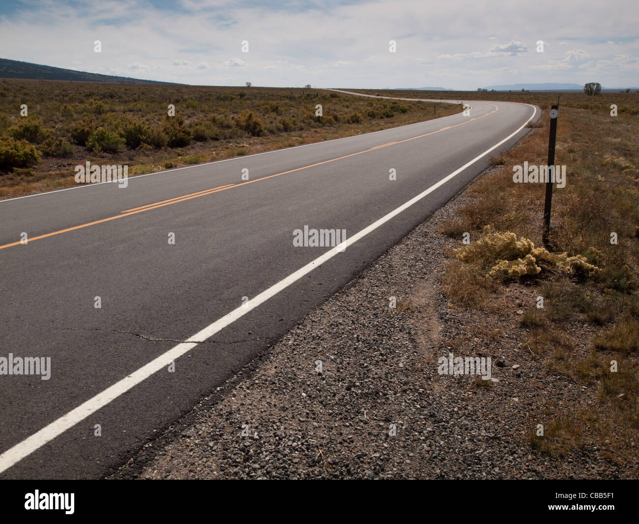 Rural paved road with yellow line Stock Photo - Alamy