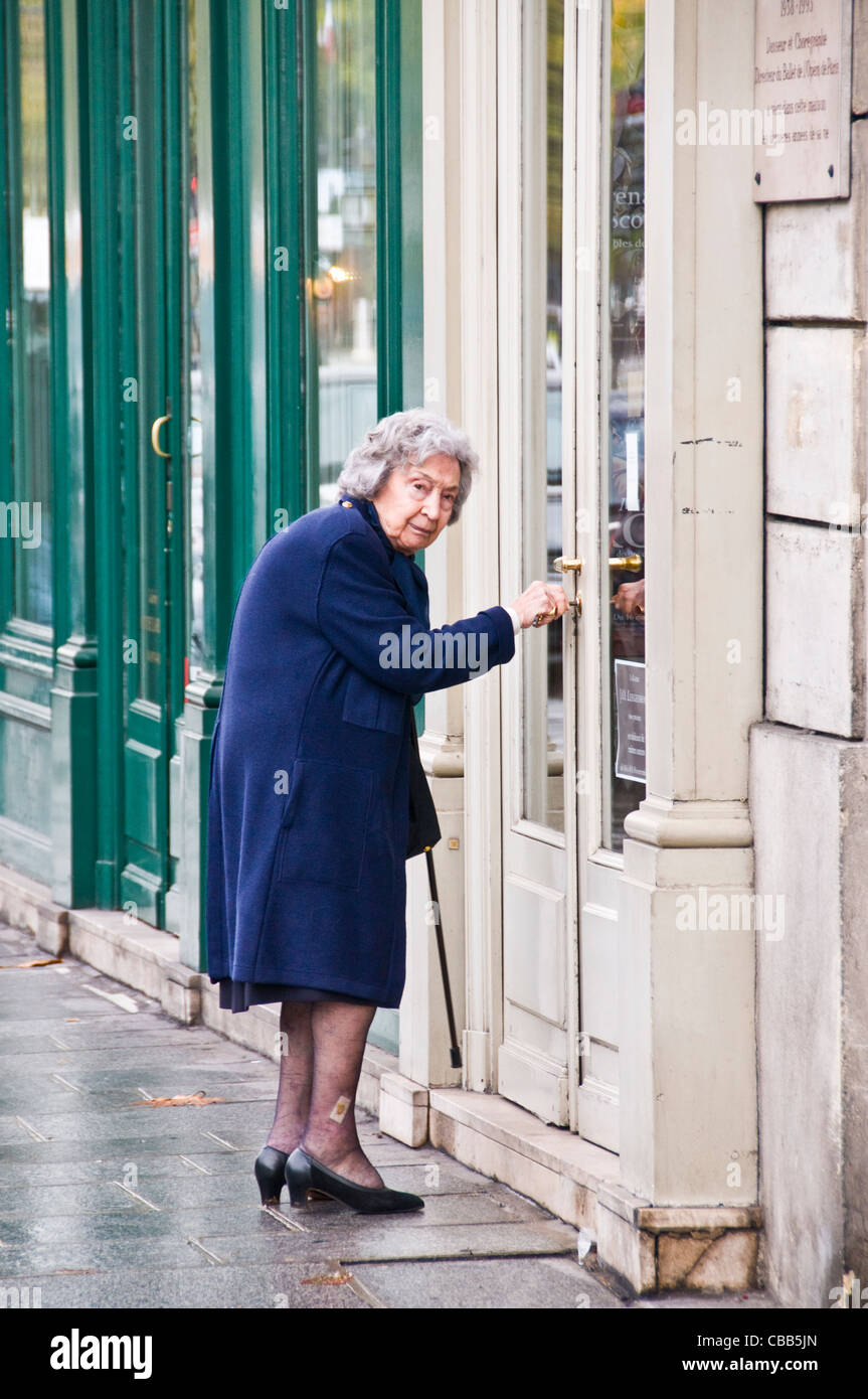 Senior lady opening door hi-res stock photography and images - Alamy