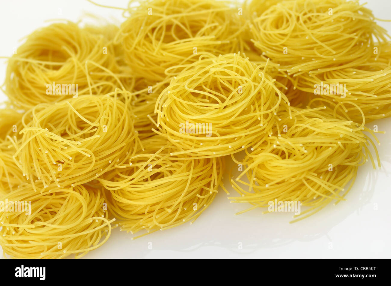 pasta nests on white background , close up Stock Photo - Alamy